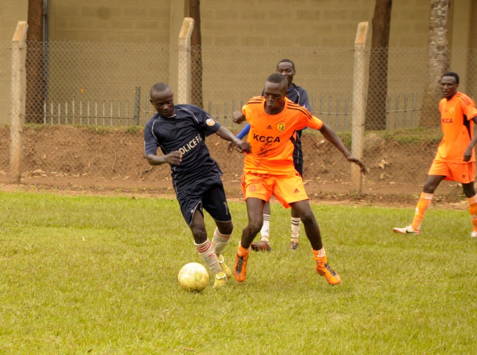 KCCA striker Tony Odur (right) battles for the ball with a Police FC ...